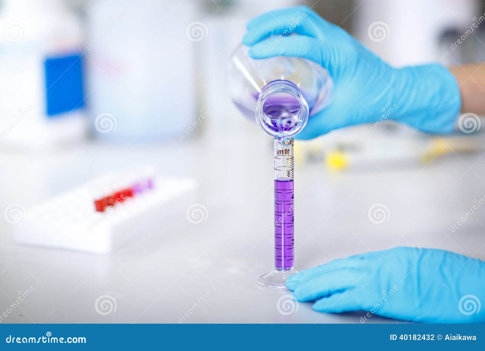 Decanting a Violet Liquid into a Graduated Cylinder Stock Photo - Image ...