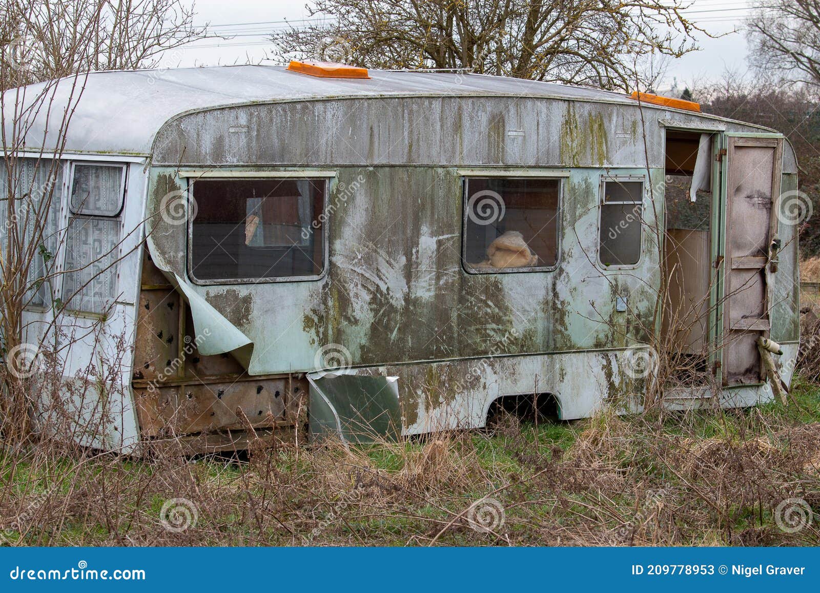 Old Broken and Decaying Caravan Left To Rot in Grass Field Stock Image ...