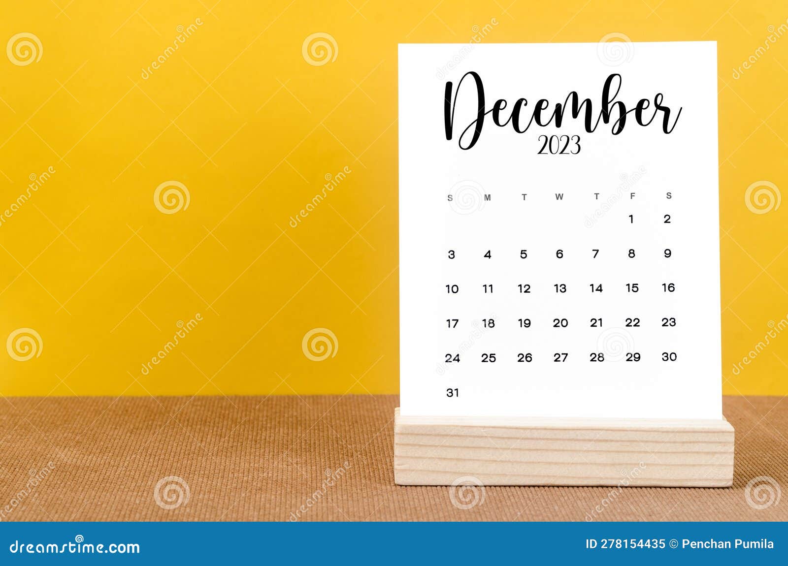 The December 2023 Monthly Calendar For 2023 Year On Yellow Table ...