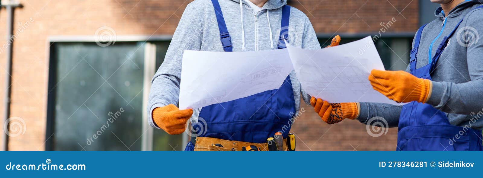 Decision Making. Two Positive Builders Smiling while Standing Outdoors ...