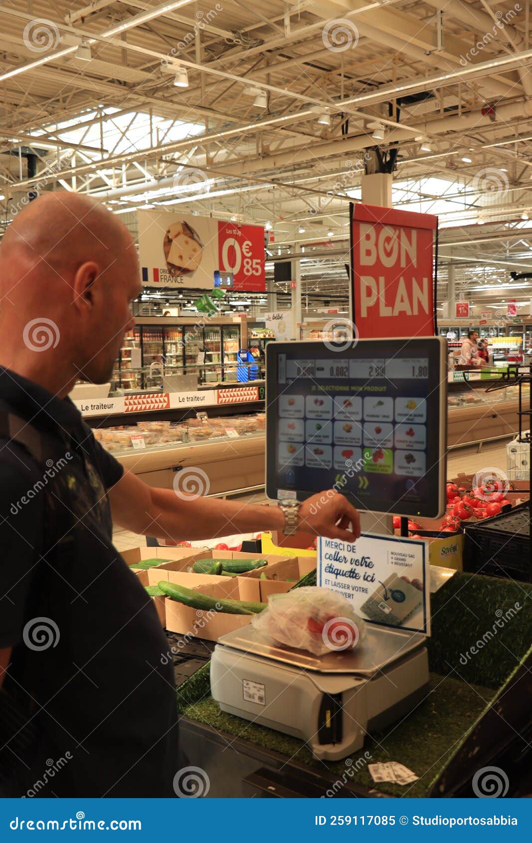 Decize, France - September 17th 2022: Customer Weighting Vegetables ... Decize, France - September 17th 2022: Customer Weighting Vegetables ...