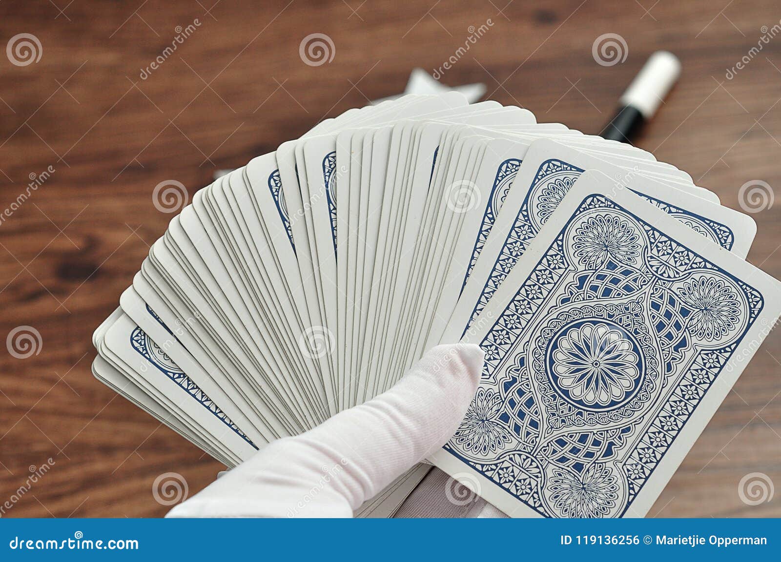 A Deck of Cards Being Held in a Magicians Hand with an Out of Focus ...