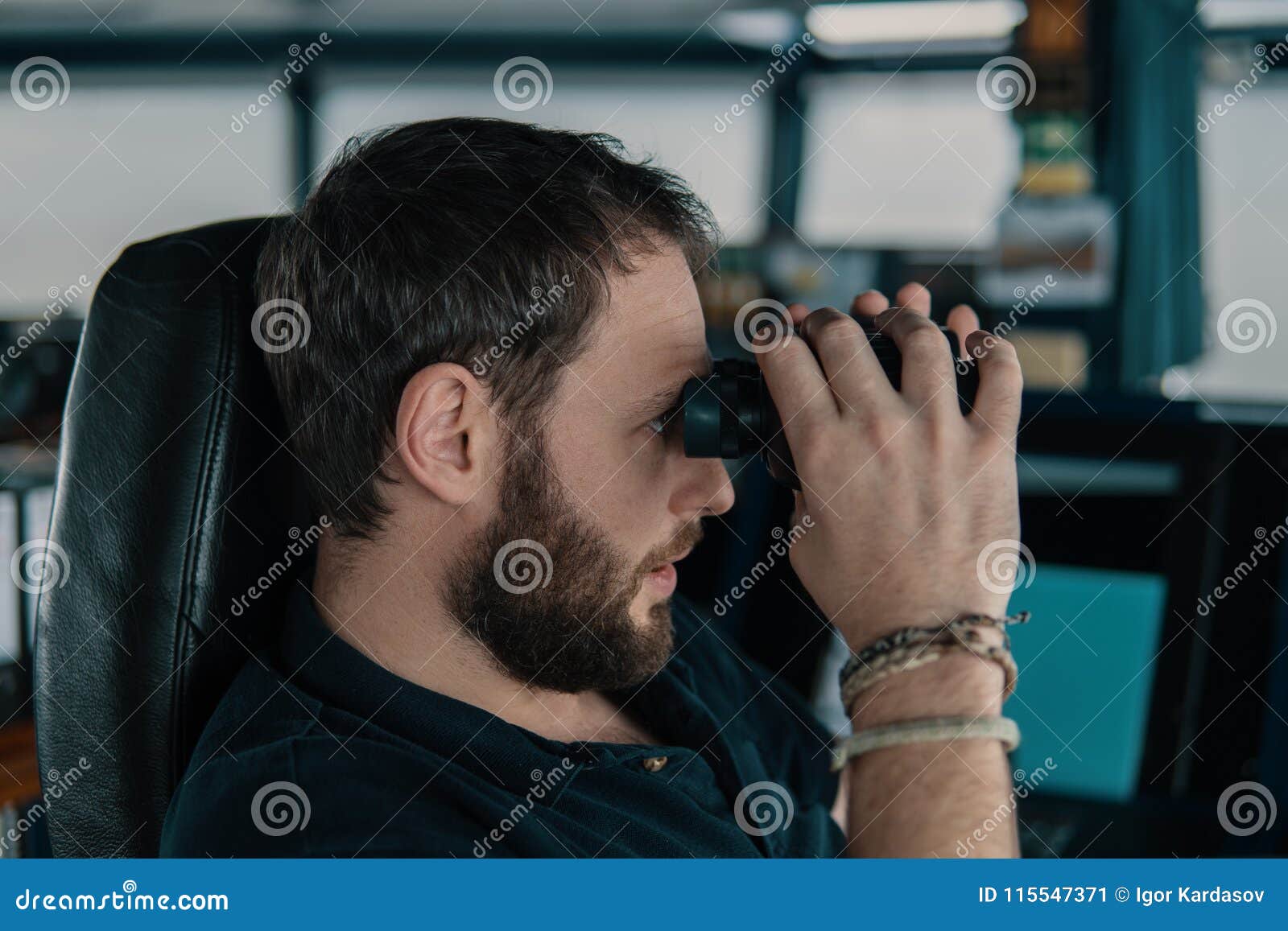 Deck Navigation Officer on the Navigation Bridge. he Looks through ...