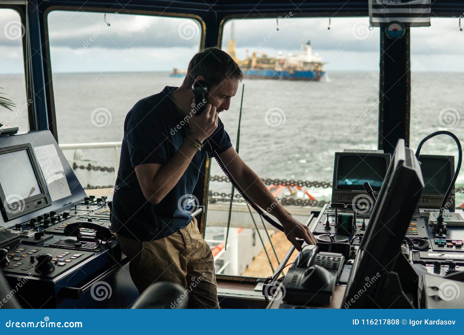 Deck Navigation Officer on the Navigation Bridge. he Looks through ...