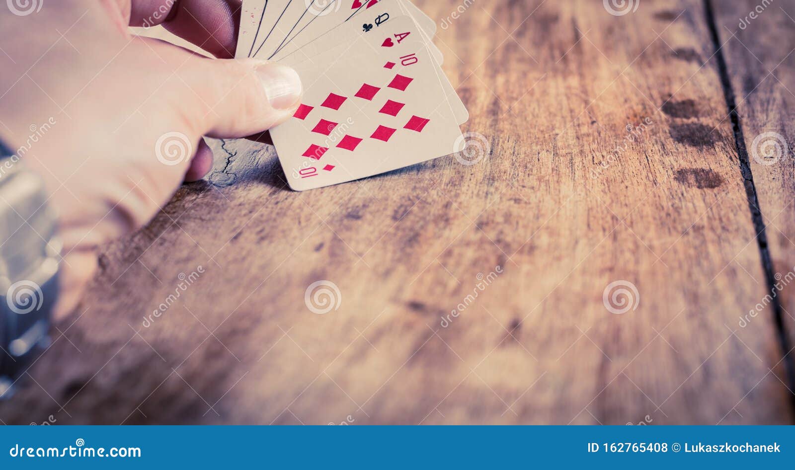 Deck of Playing Cards in a Hand on a Wooden Vintage Table Stock Photo ...