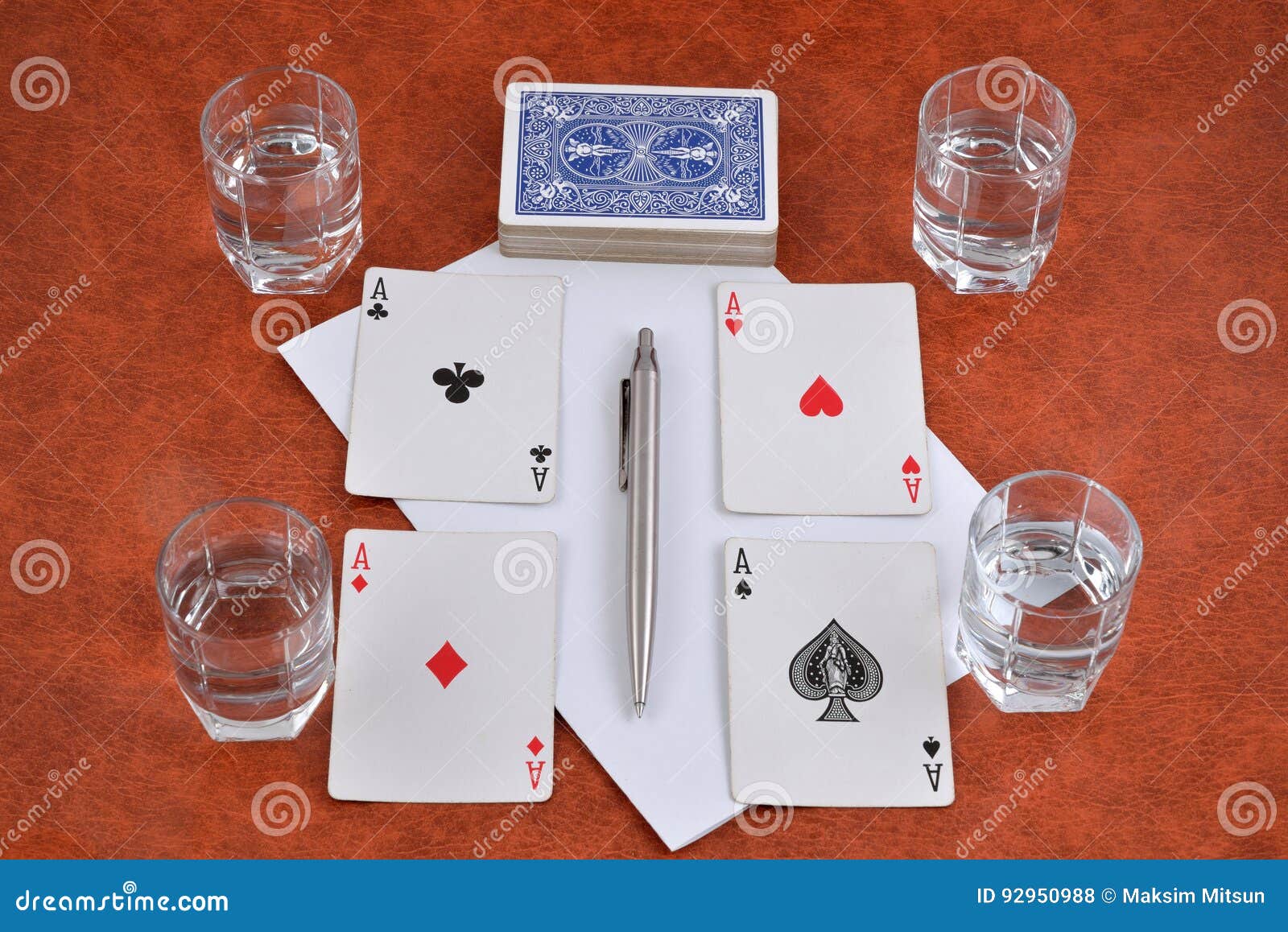 A Deck of Playing Cards, Pen, Paper and Stacks of Vodka on the T ...