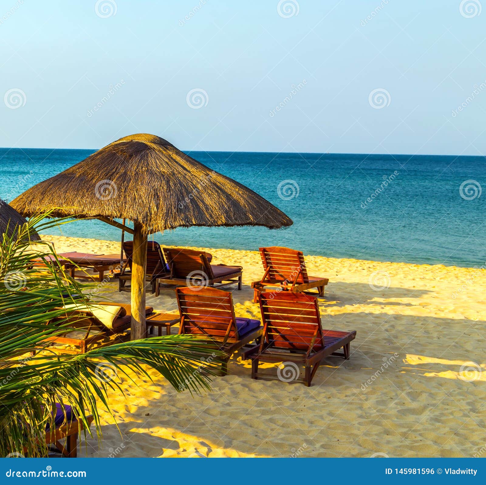 Deckchairs Umbrella Chair Parasol on the Tropical Sand Beach Stock ...
