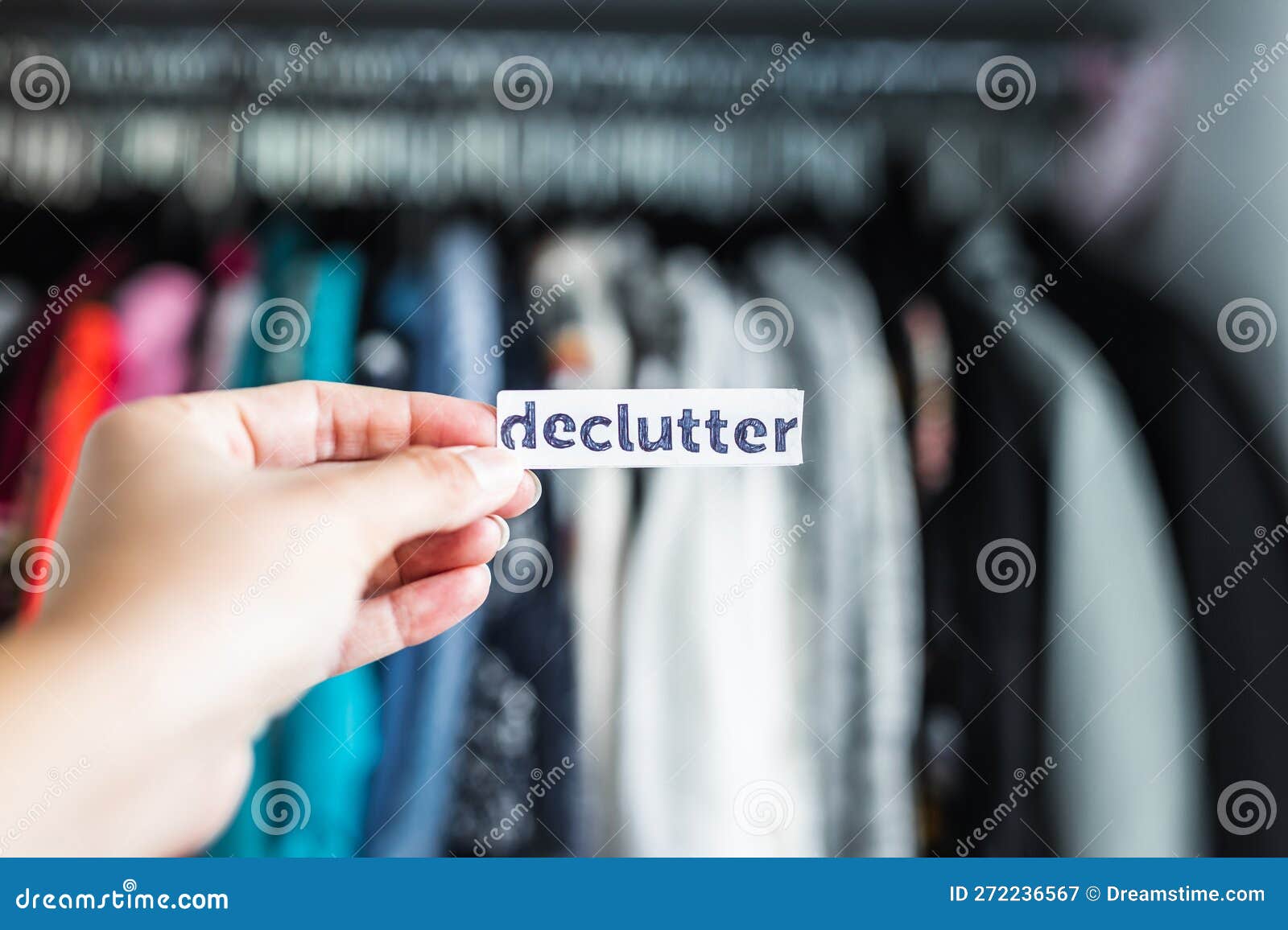 Shopping and Consumerism, Declutter Sign Held in Front of Wardrobe Full ...