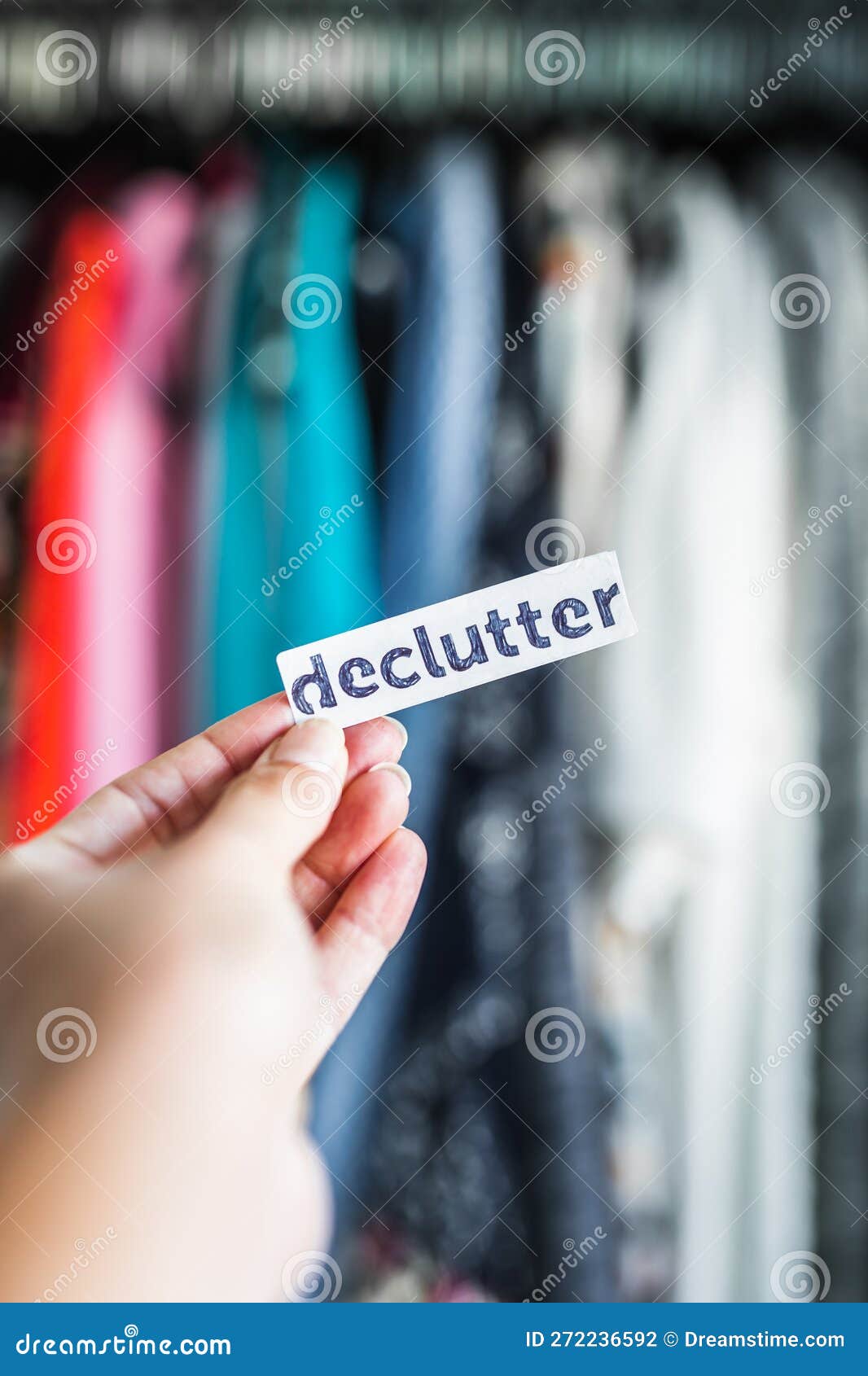 Shopping and Consumerism, Declutter Sign Held in Front of Wardrobe Full ...