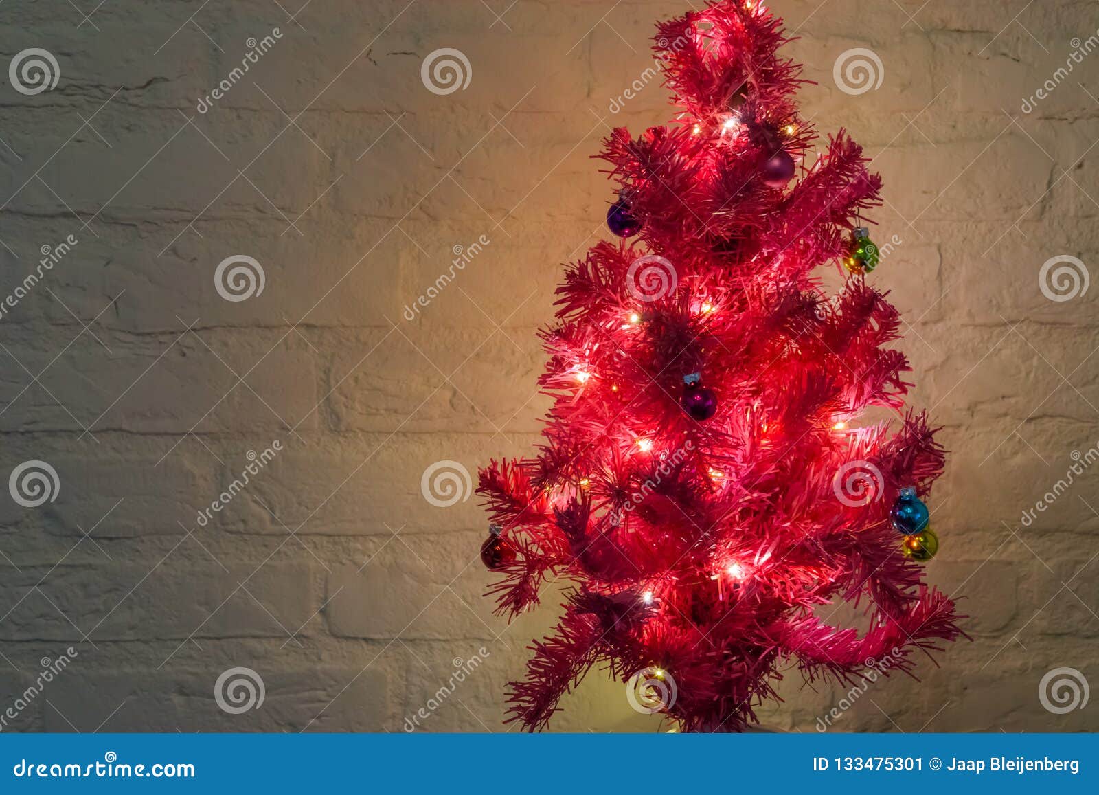 Decorated Christmas Tree with Lighted Lights Isolated on a White Brick ...