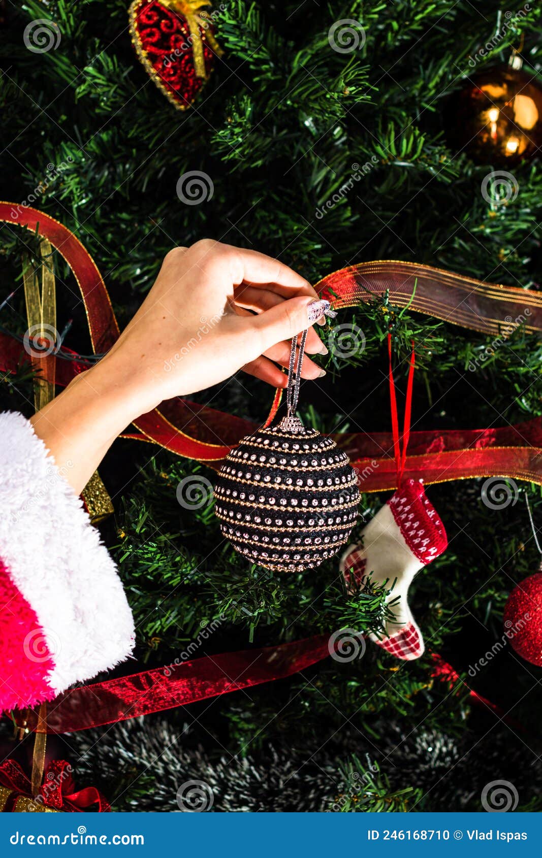Decorating Christmas Tree, Hand Putting Christmas Decorations on Fir ...