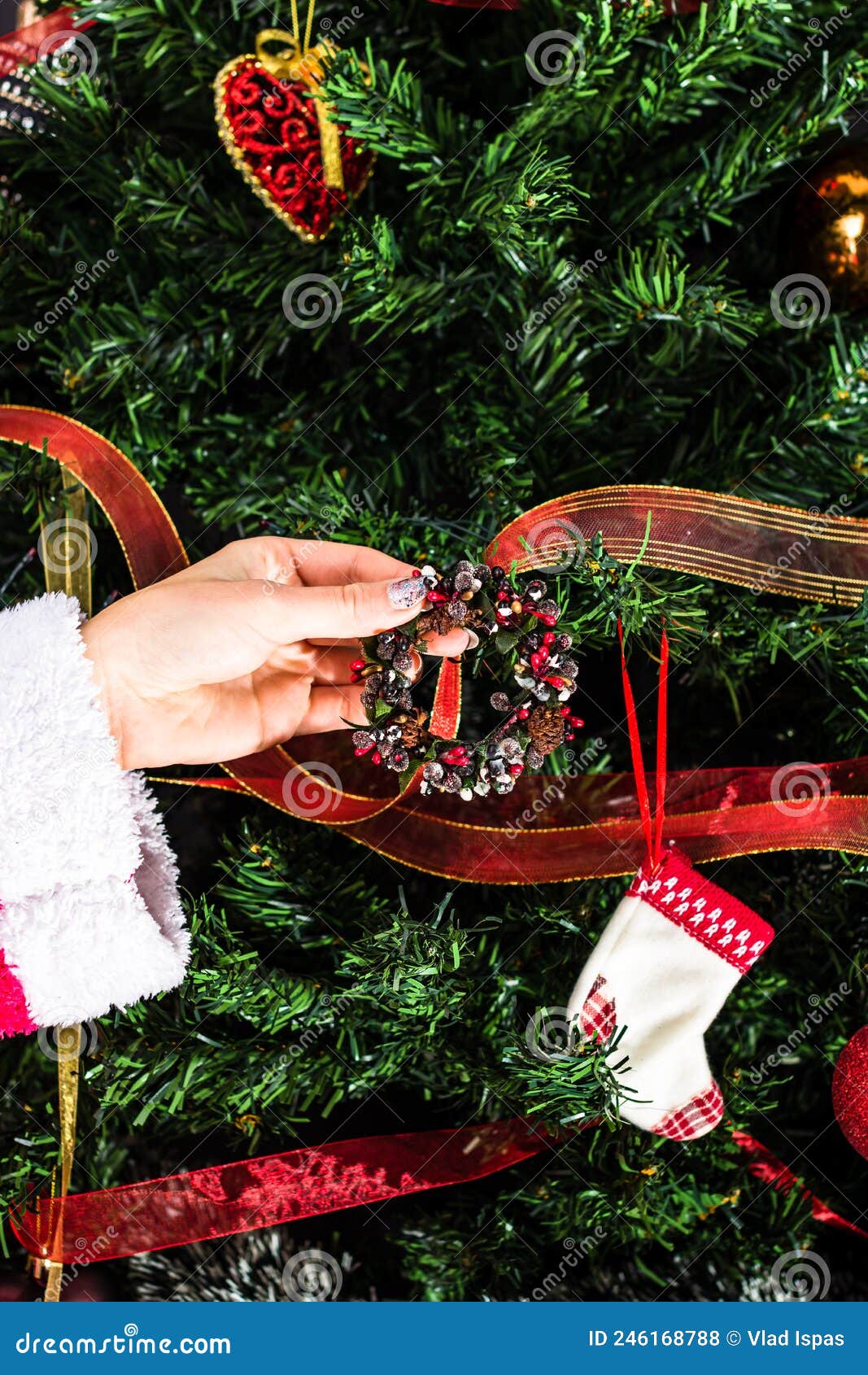 Decorating Christmas Tree, Hand Putting Christmas Decorations on Fir ...