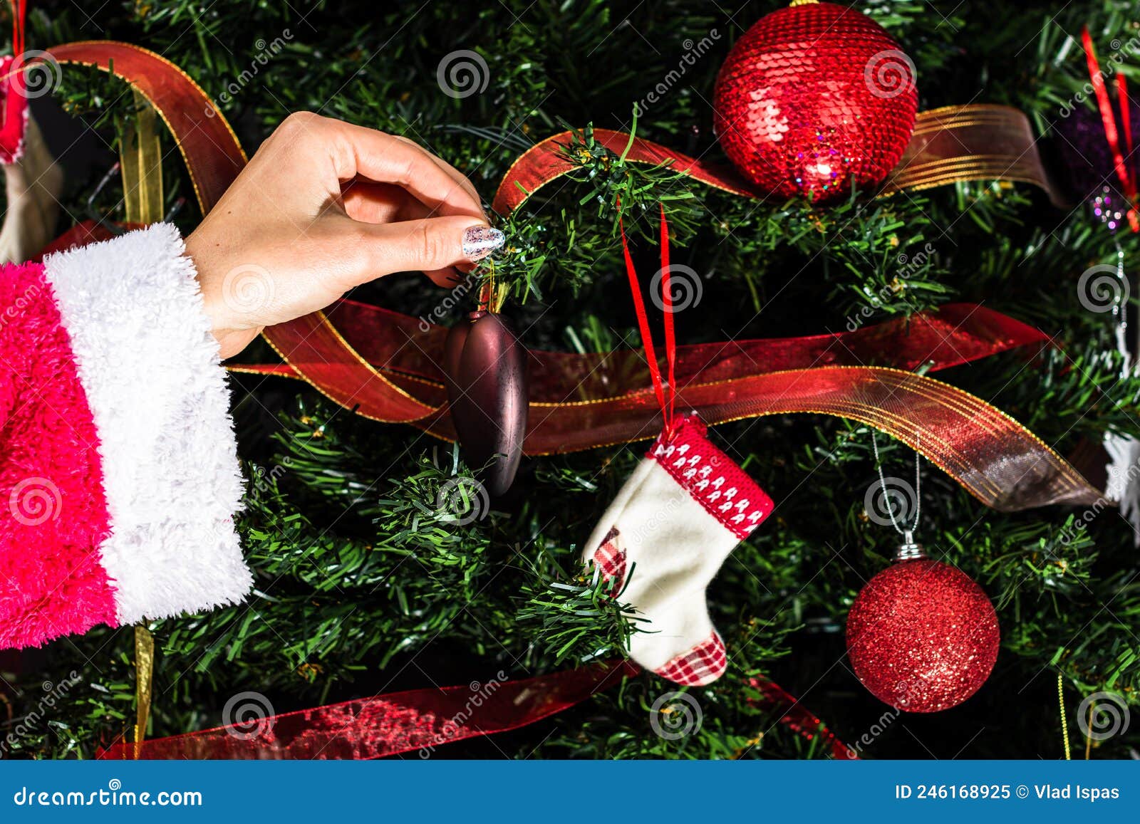 Decorating Christmas Tree, Hand Putting Christmas Decorations on Fir ...