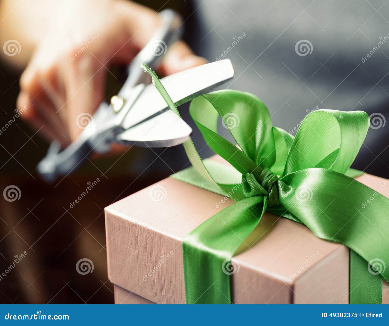 Decorating Gift Box with Green Ribbon Using Scissor Stock Image - Image ...