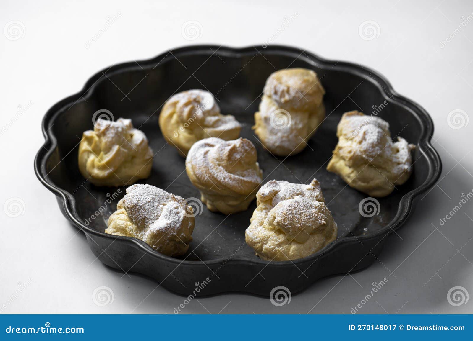 Decorating Profiteroles with Powdered Sugar. Eclairs . Stock Image ...