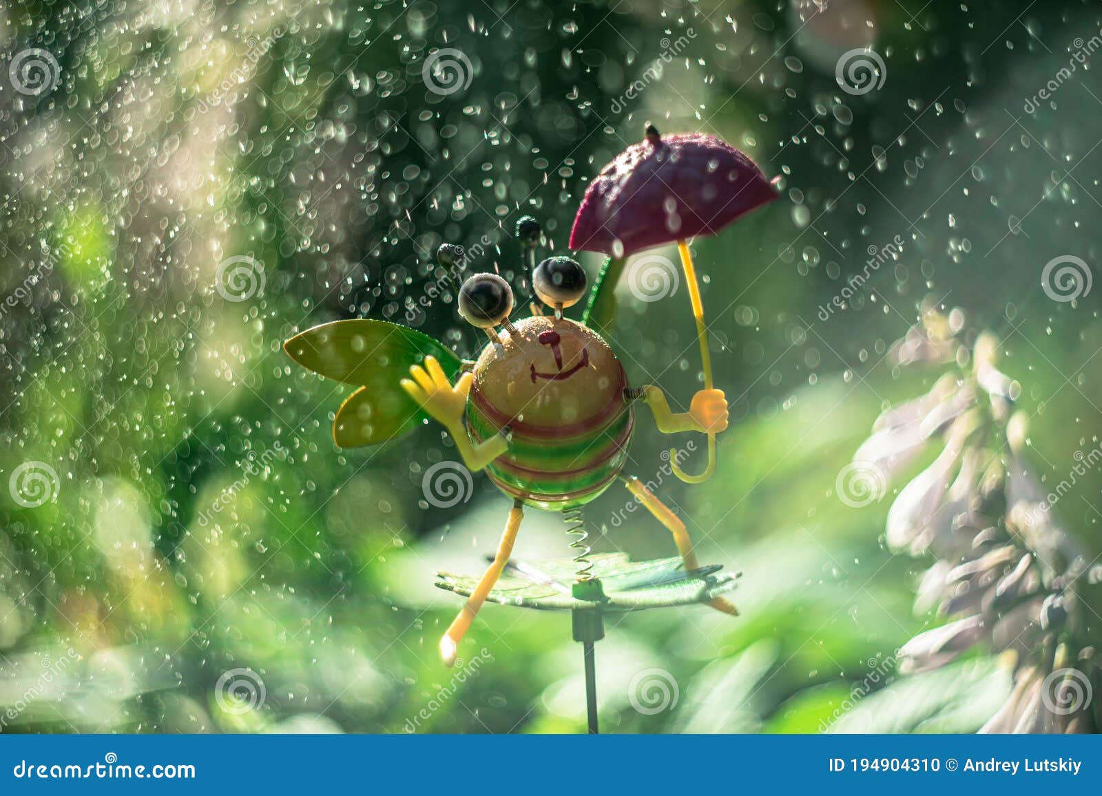 Decorative Bee with an Umbrella Under Raindrops, Figurine in the Garden ...