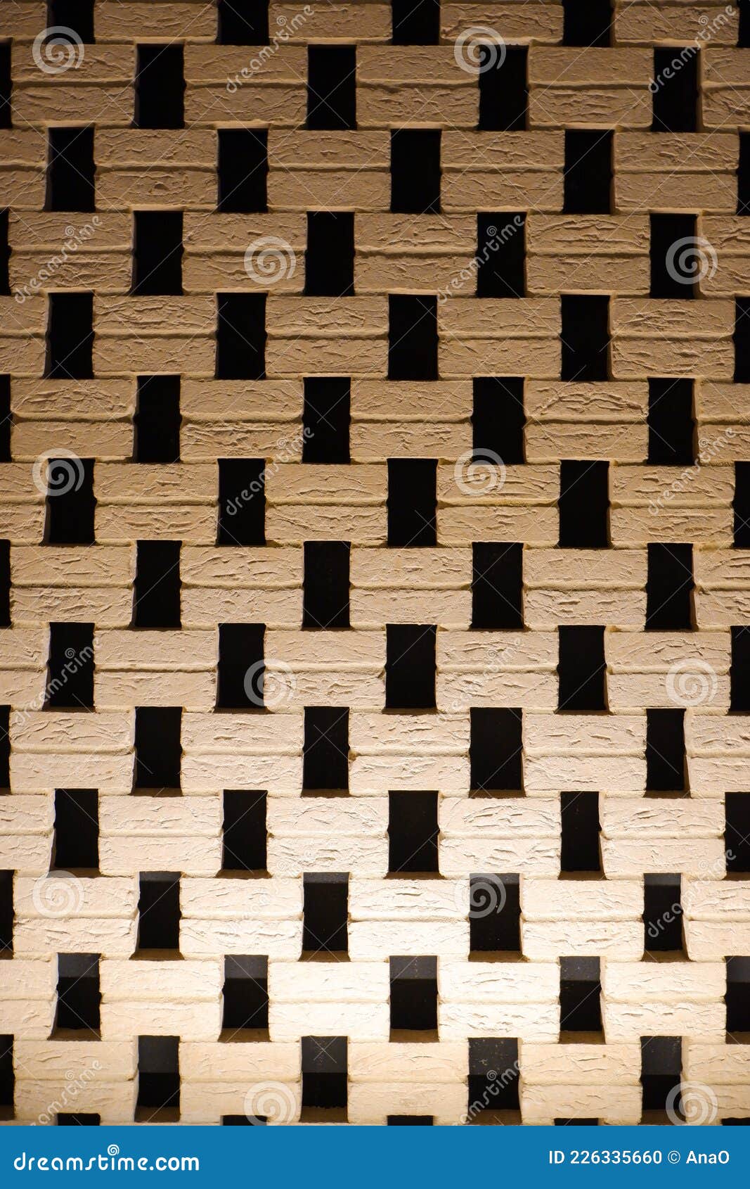 Decorative Brick Wall with Holes Illuminated by Spotlights. Abstract ...