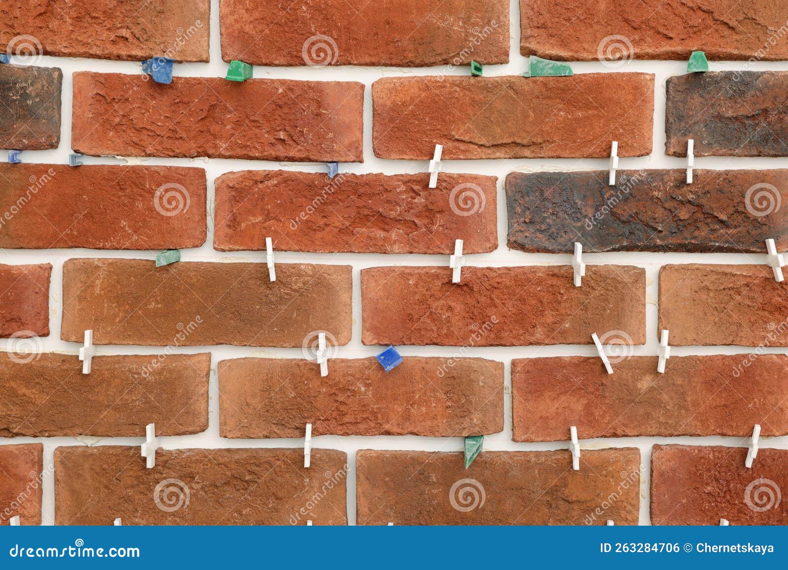 Decorative Bricks with Tile Leveling System on Wall Stock Photo - Image ...