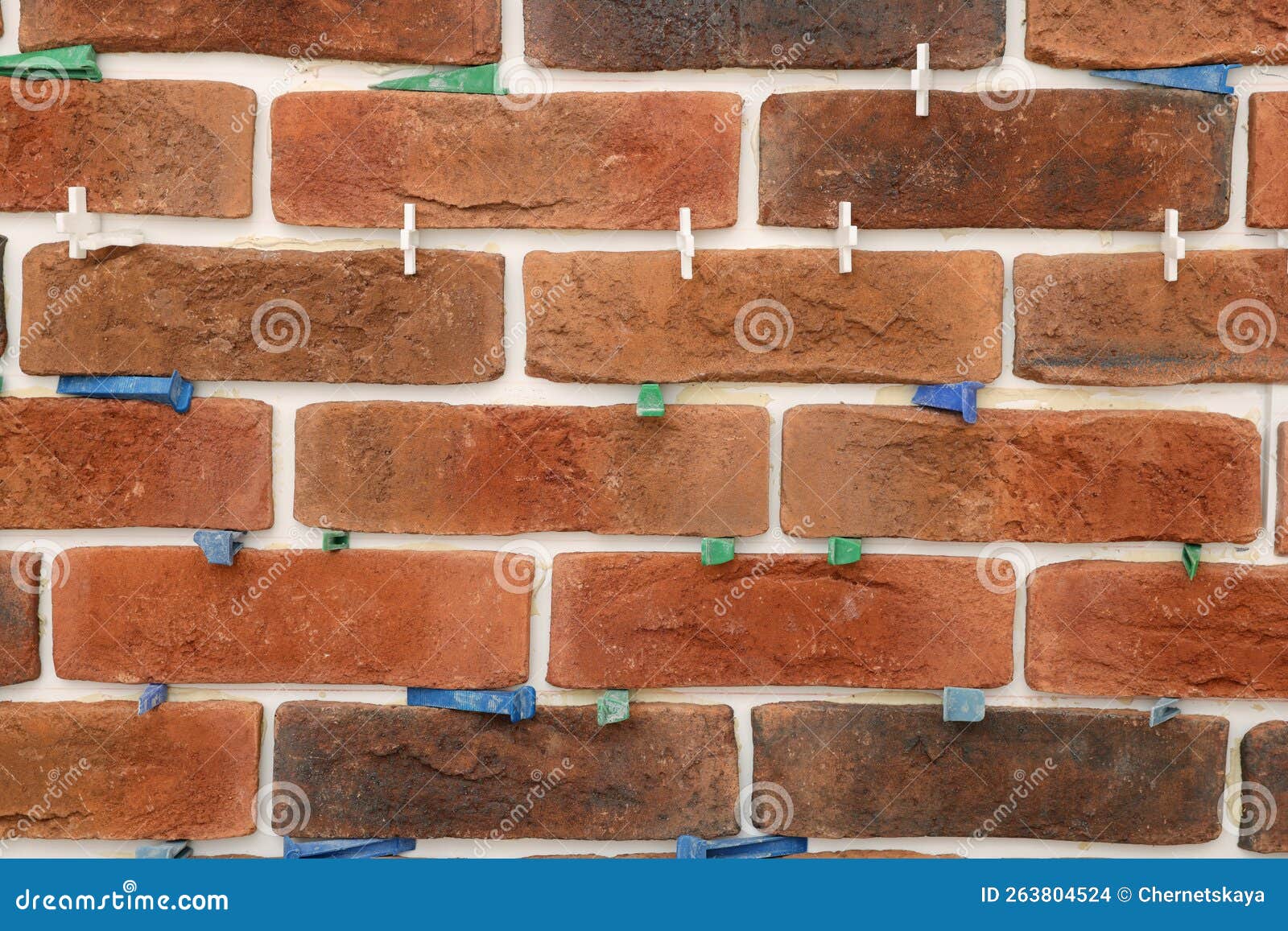 Decorative Bricks with Tile Leveling System on Wall Stock Photo - Image ...