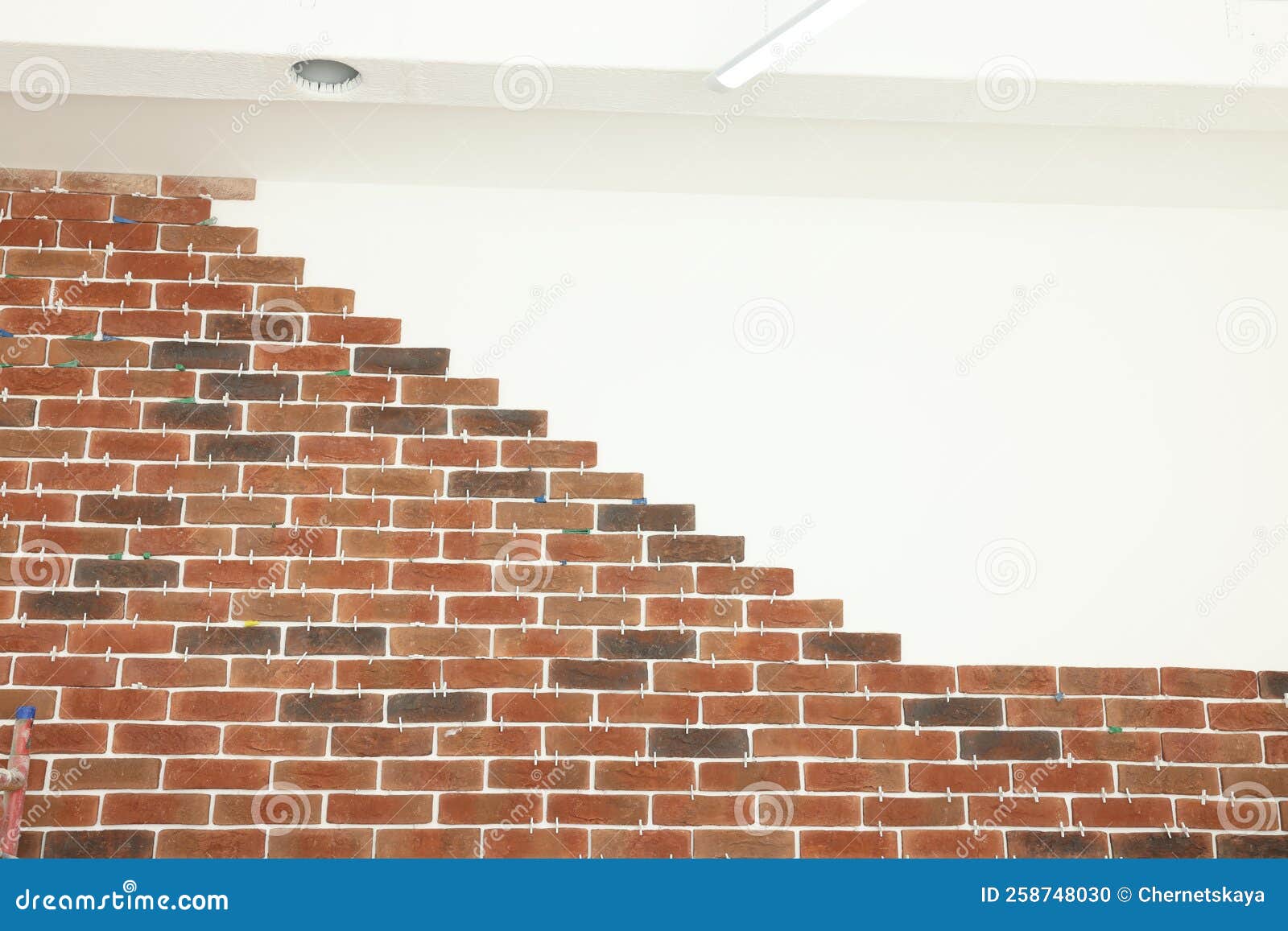 Decorative Bricks with Tile Leveling System on White Wall Stock Photo ...