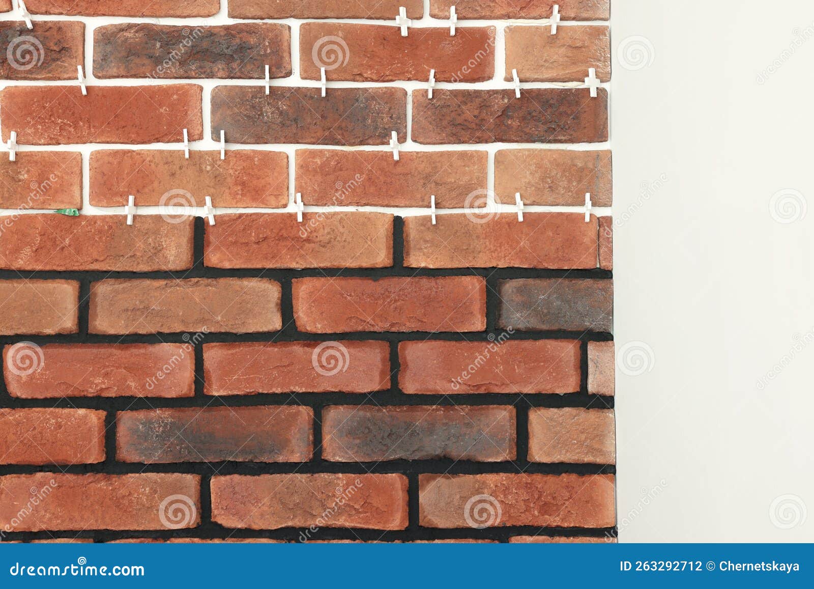 Decorative Bricks with Tile Leveling System on White Wall Stock Photo ...