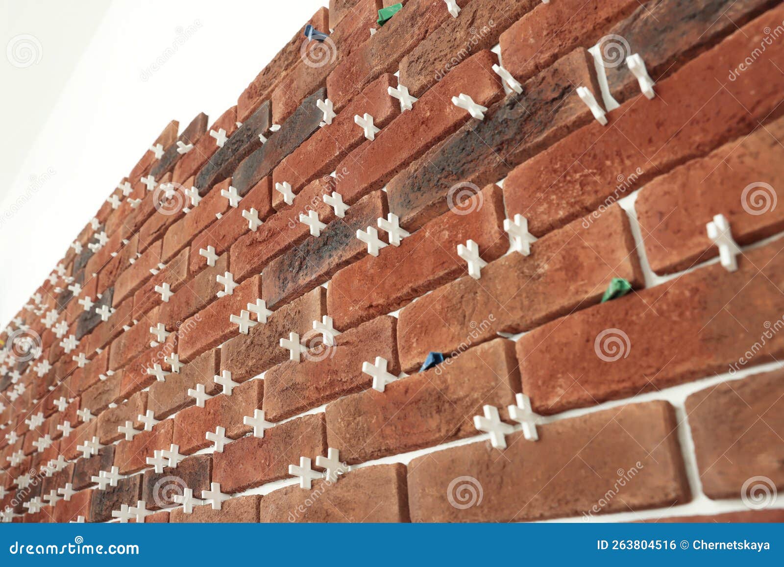 Decorative Bricks with Tile Leveling System on White Wall Stock Photo ...
