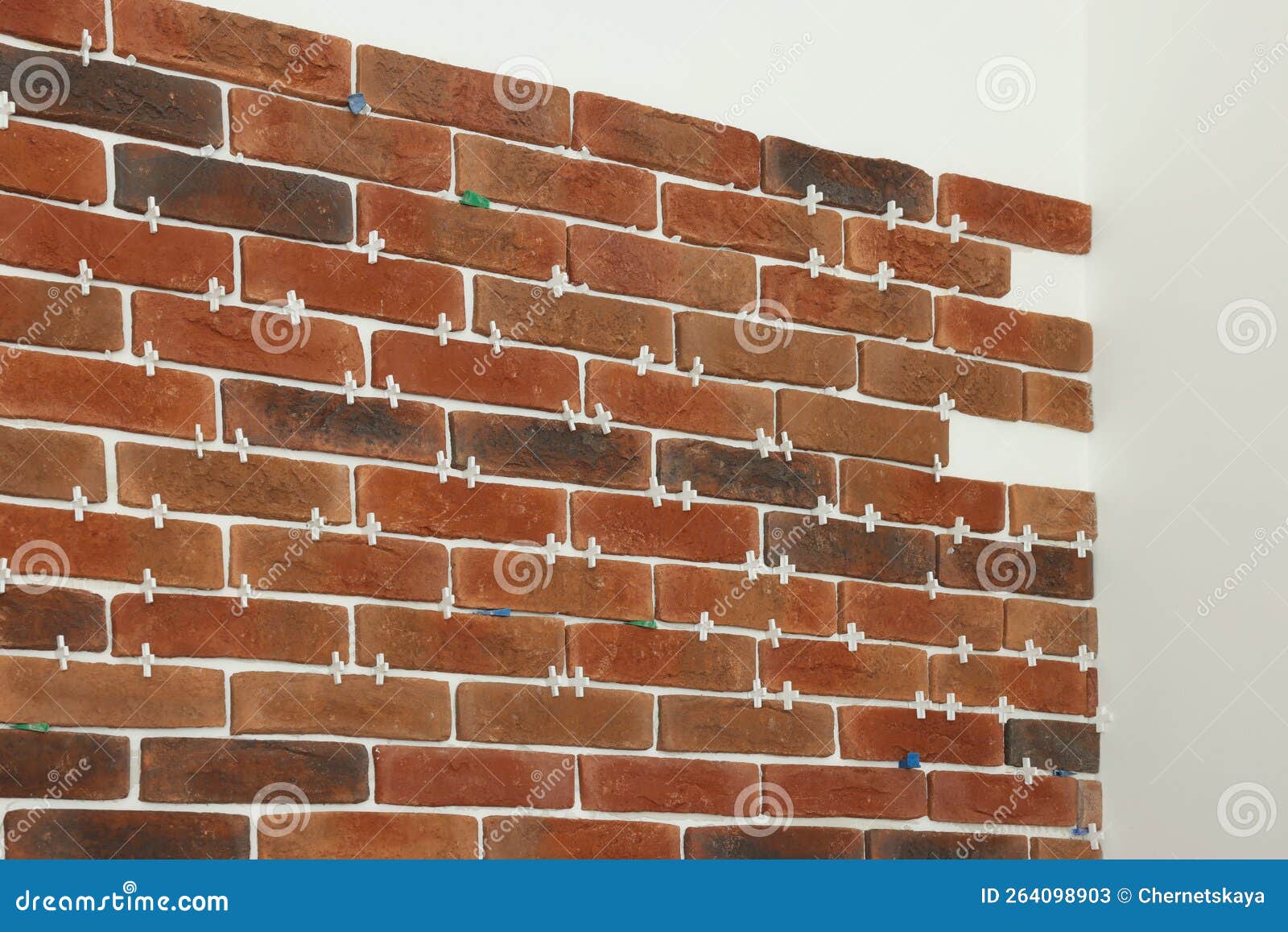 Decorative Bricks with Tile Leveling System on White Wall Stock Image ...