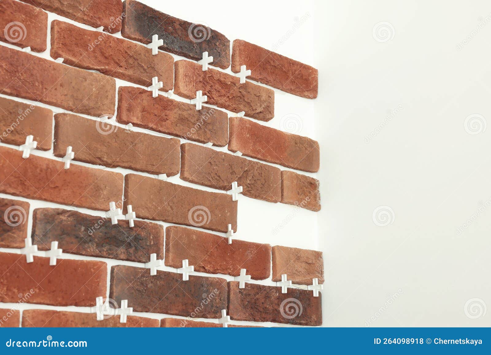 Decorative Bricks with Tile Leveling System on White Wall Stock Photo ...