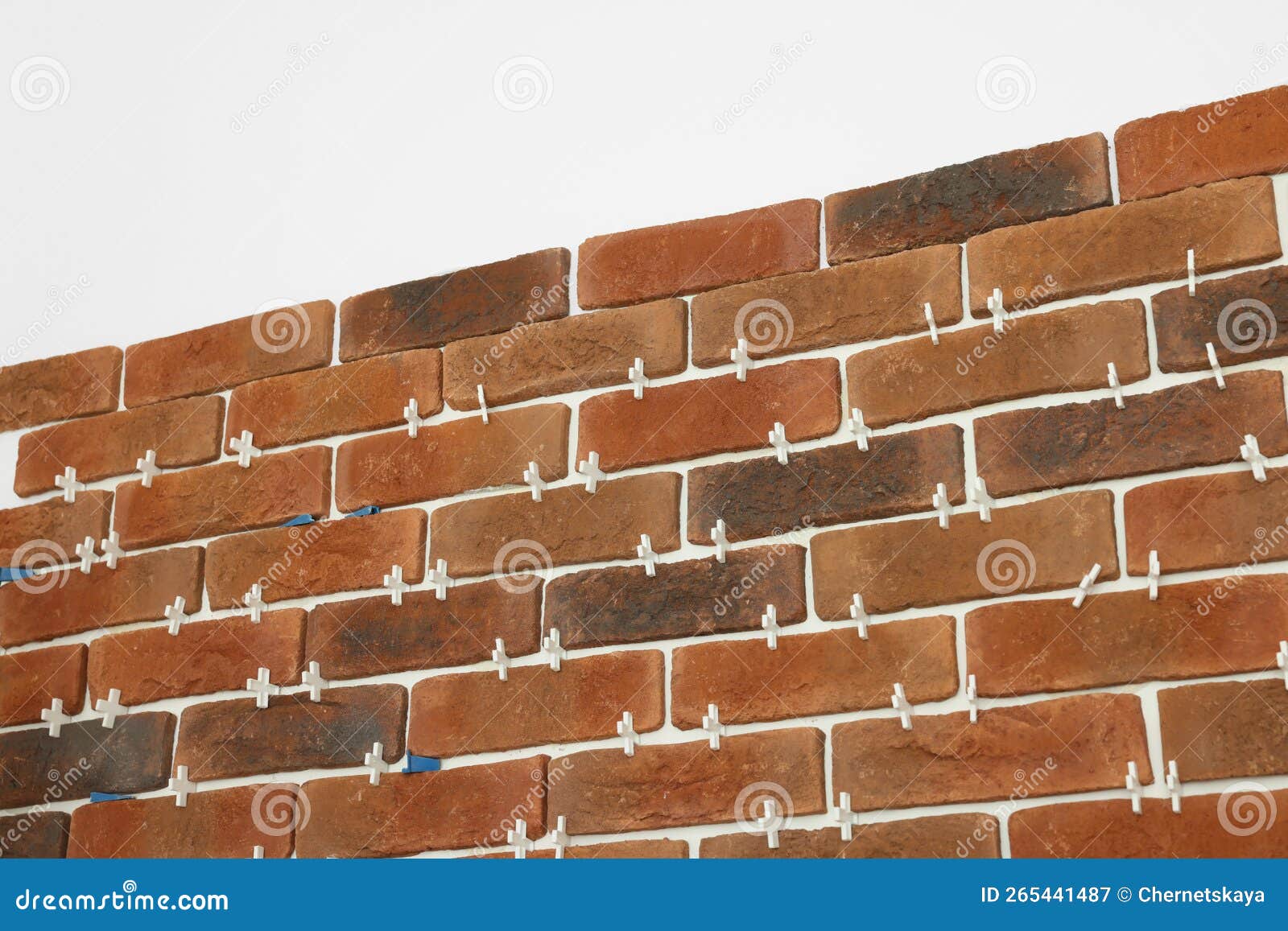 Decorative Bricks with Tile Leveling System on White Wall Stock Image ...