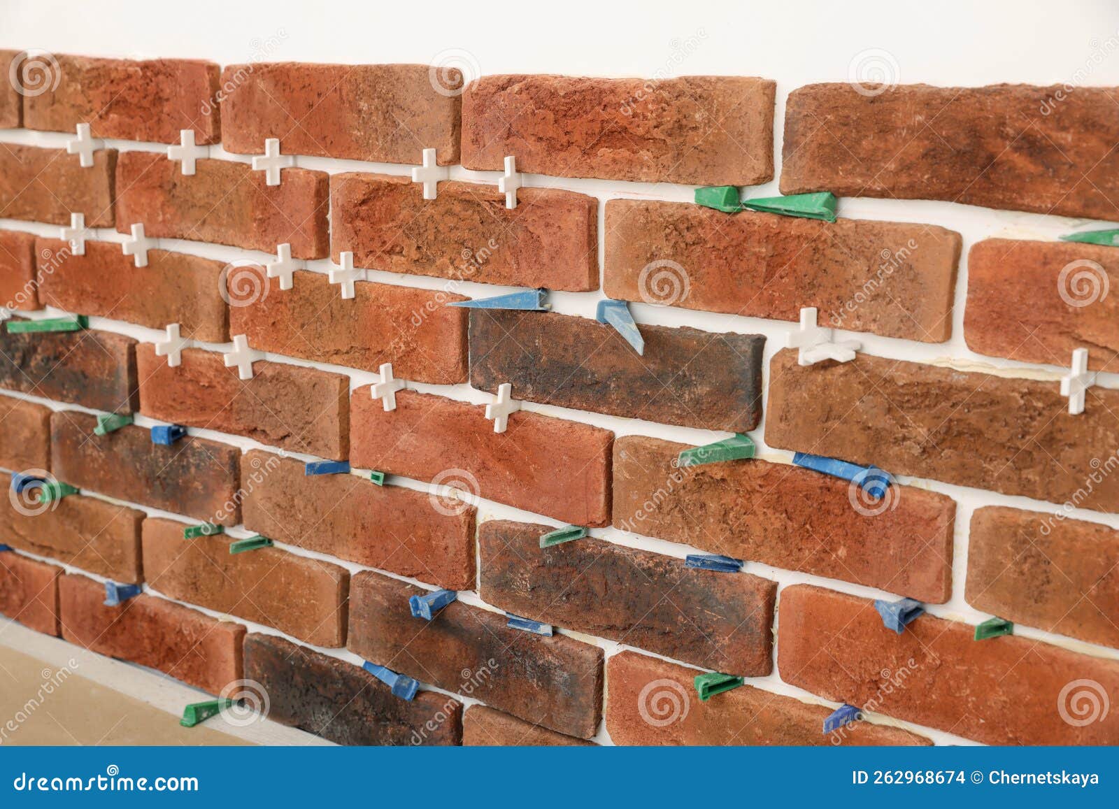 Decorative Bricks with Tile Leveling System on White Wall in Room Stock ...