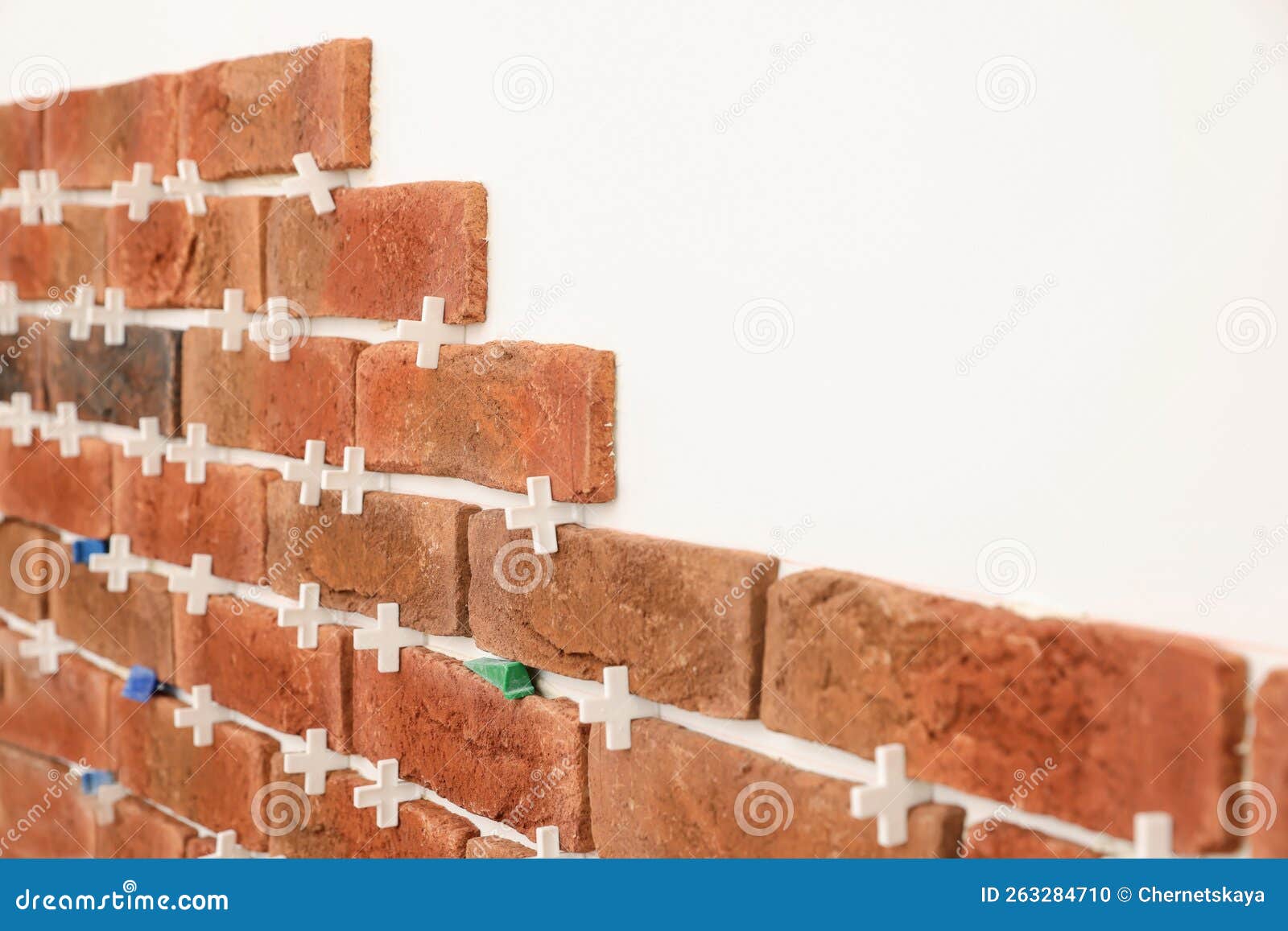 Decorative Bricks with Tile Leveling System on White Wall in Room Stock ...