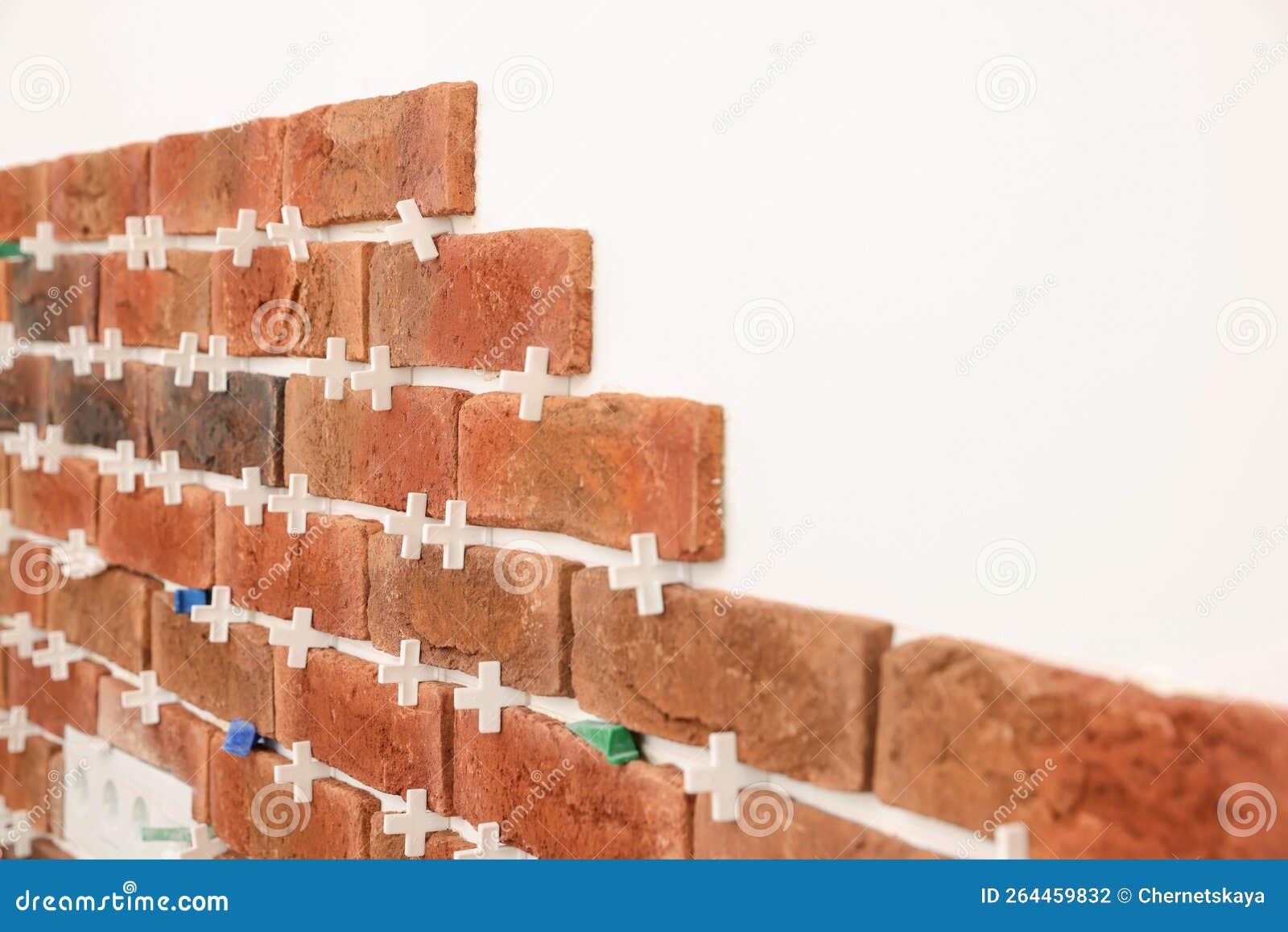 Decorative Bricks with Tile Leveling System on White Wall in Room Stock ...