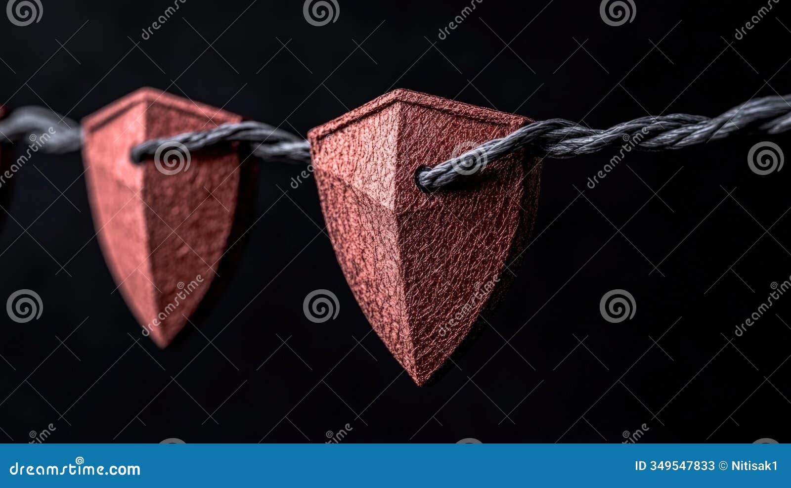 Decorative Copper Shields Hanging on a Rope Dark Background Stock ...