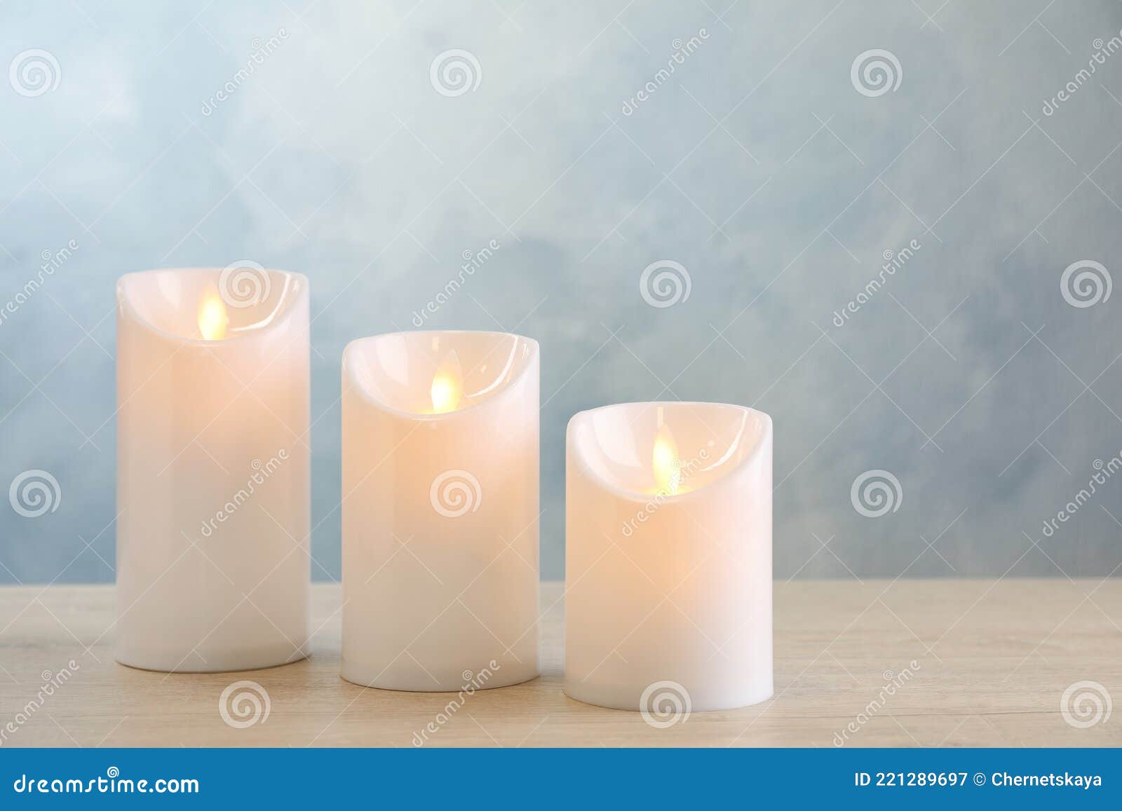 Decorative LED Candles on Light Wooden Table Stock Image - Image of ...
