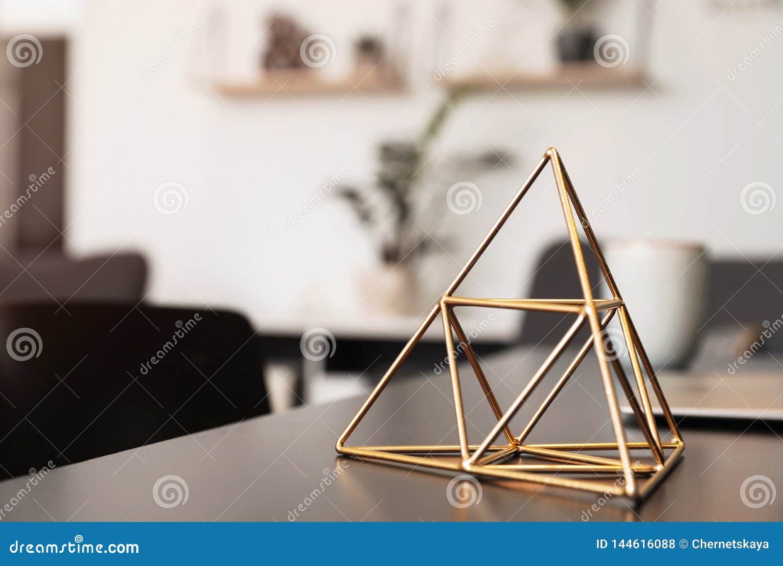 Decorative Metal Pyramid on Table in Room. Stock Photo - Image of ...