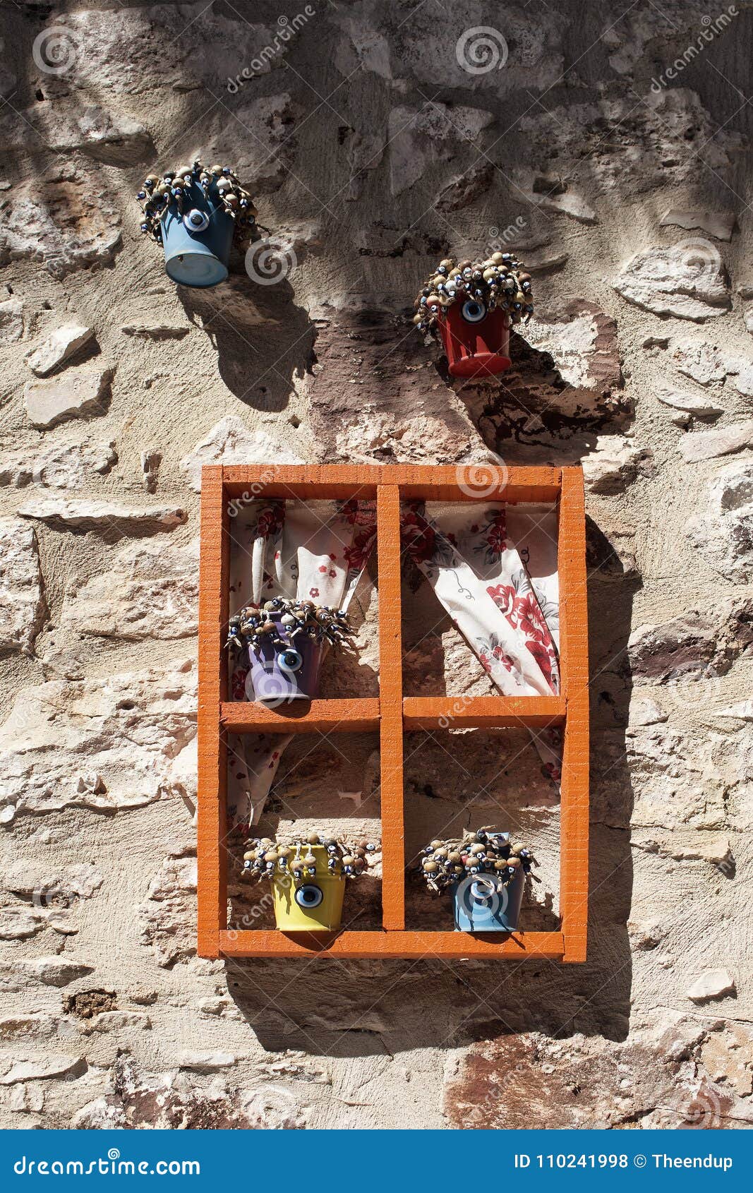 Decorative Objects on Old Stone Wall Stock Photo - Image of eyes, evil ...