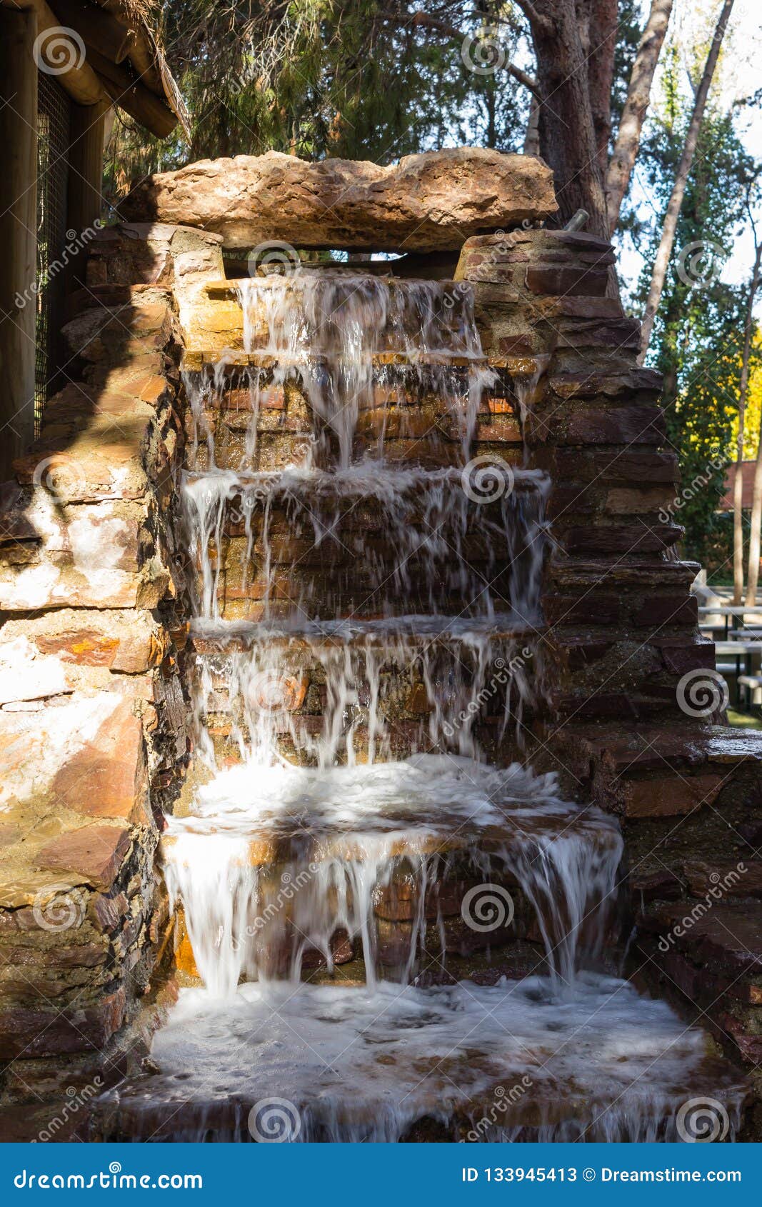Decorative stone waterfall stock image. Image of green - 133945413