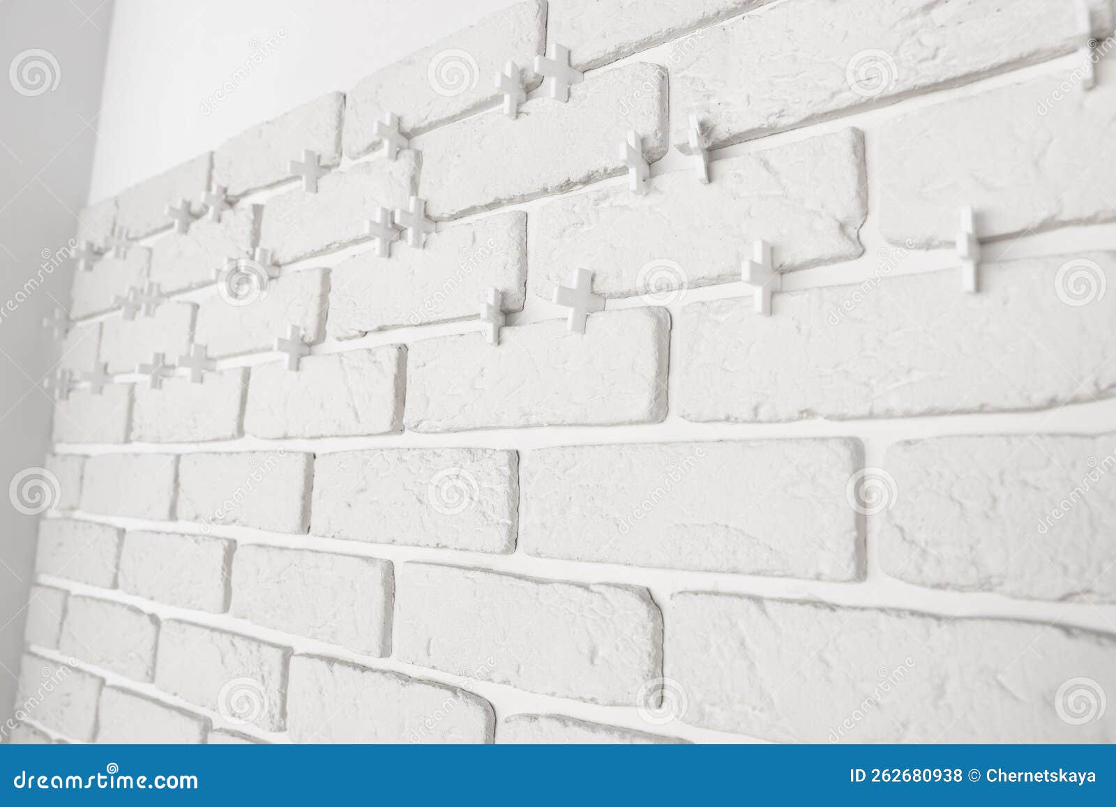 Decorative White Bricks with Tile Leveling System on Wall Stock Photo ...