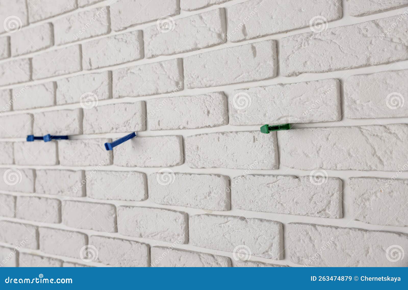 Decorative White Bricks with Tile Leveling System on Wall Stock Image ...