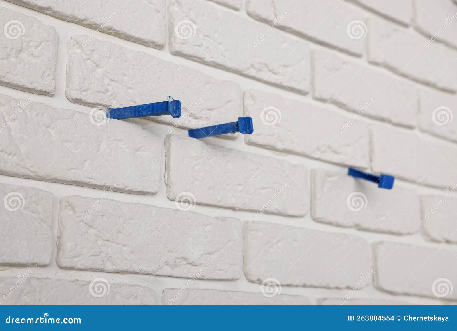 Decorative White Bricks with Tile Leveling System on Wall, Closeup ...