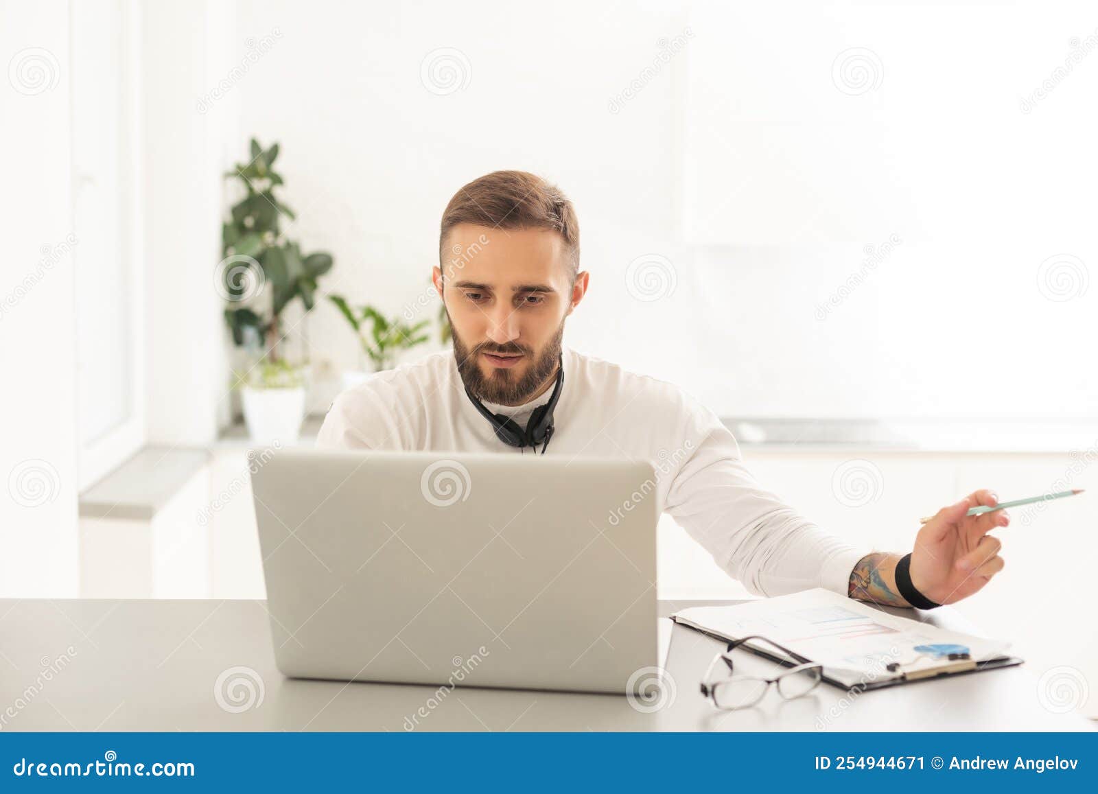 Dedicated Entrepreneur Sitting at Office Desk and Reading an E-mail ...
