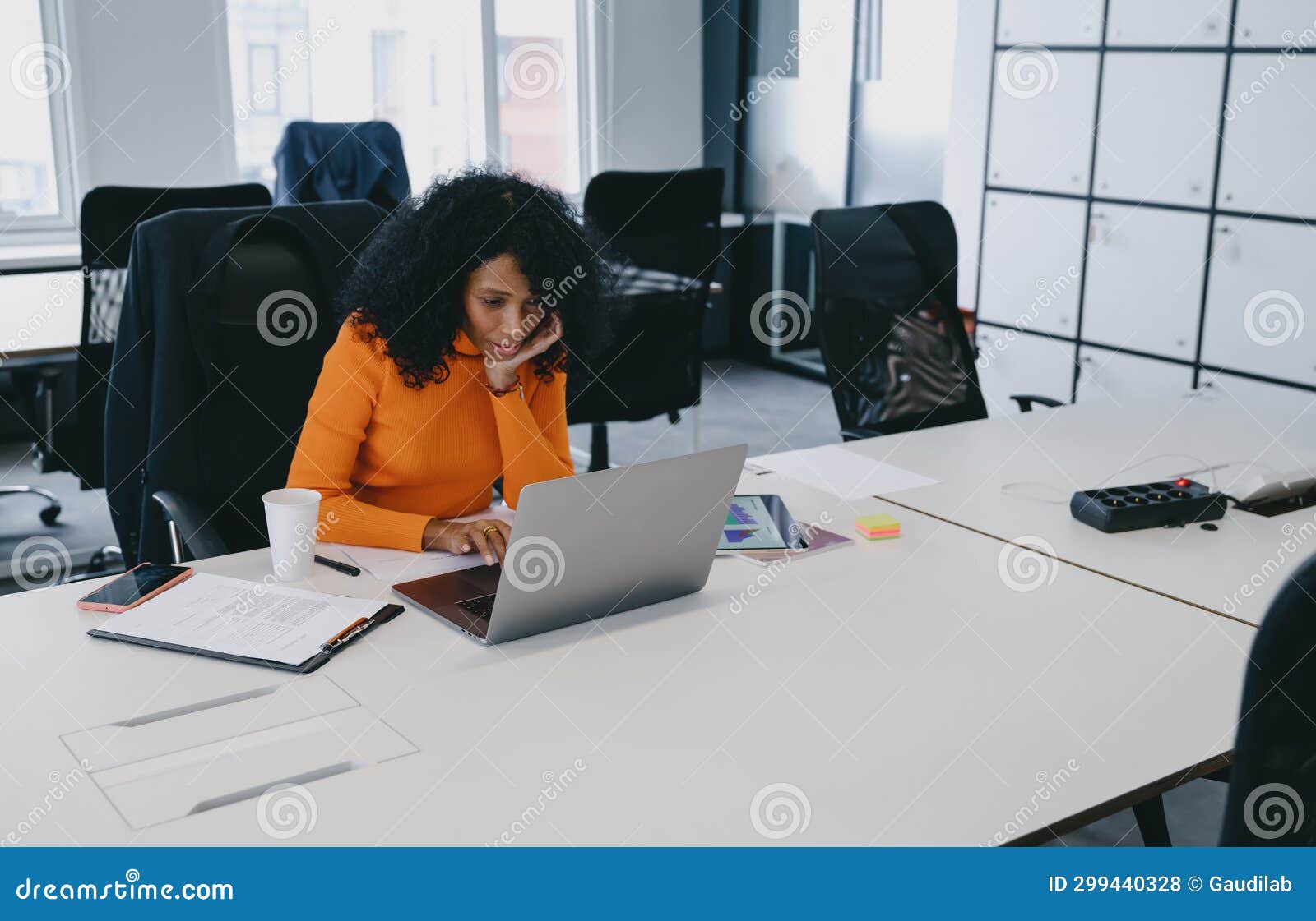 Dedicated Professional Deeply Focused on Analyzing Data on a Laptop, in ...