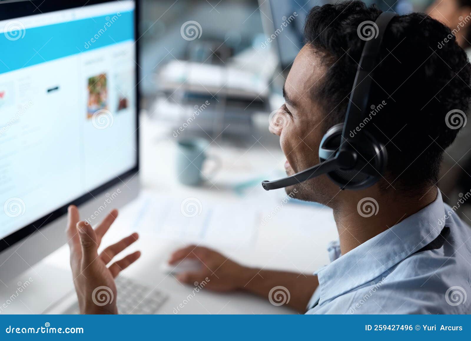 Dedicated Support at Your Service. a Young Man Using a Headset and ...