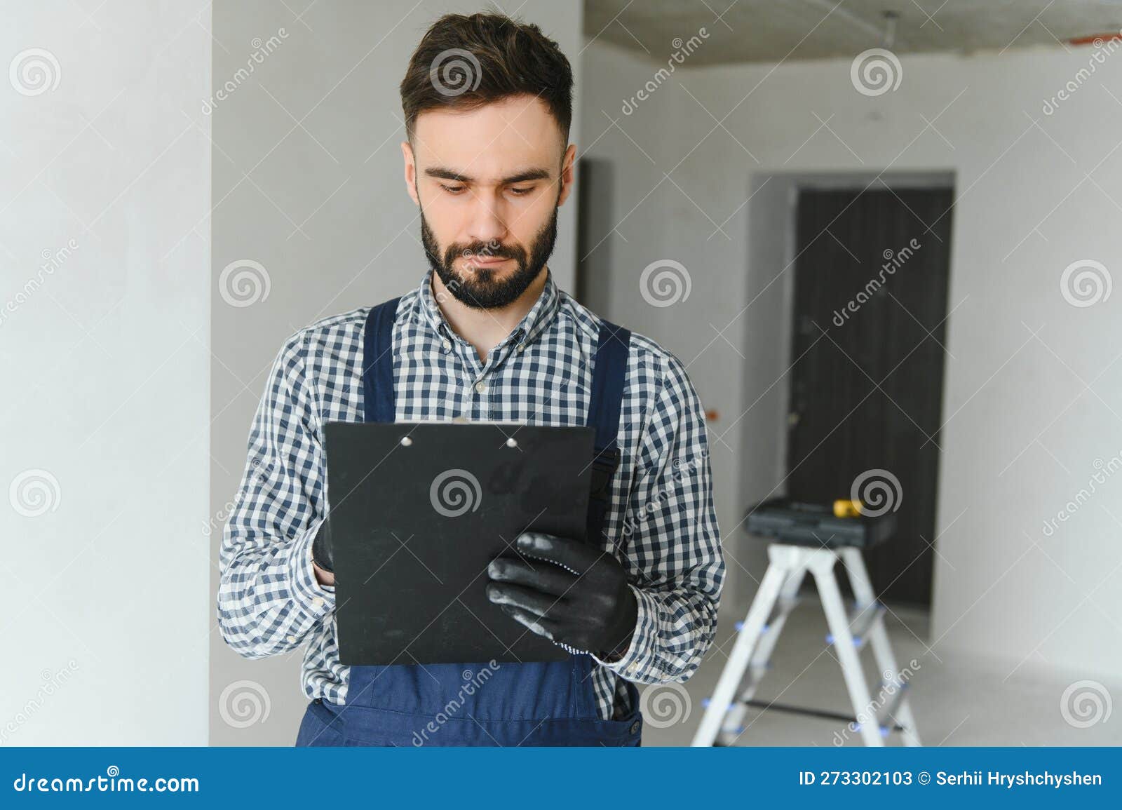 A Dedicated Worker Doing Calculations for Material for Apartment in ...