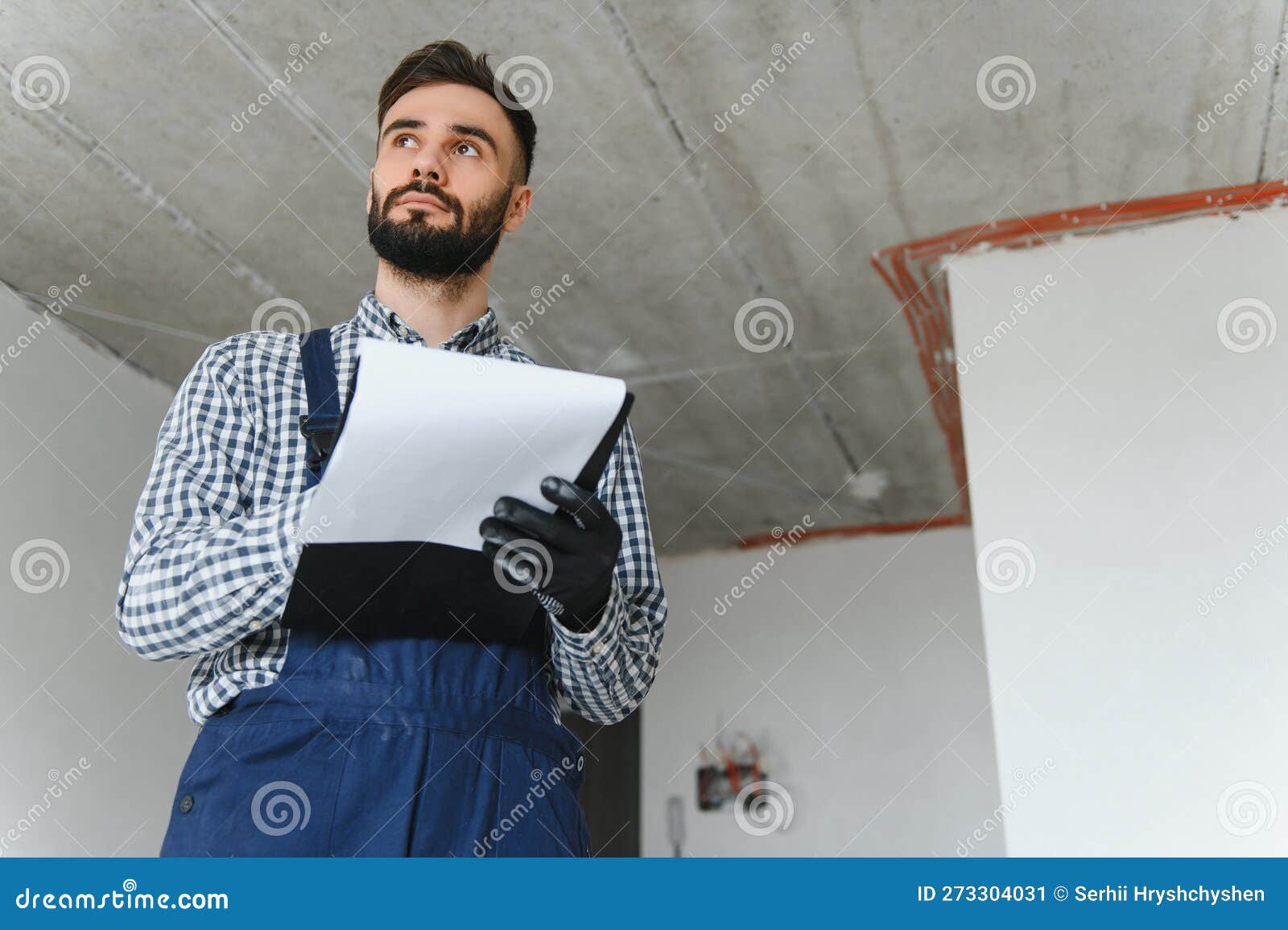 A Dedicated Worker Doing Calculations for Material for Apartment in ...
