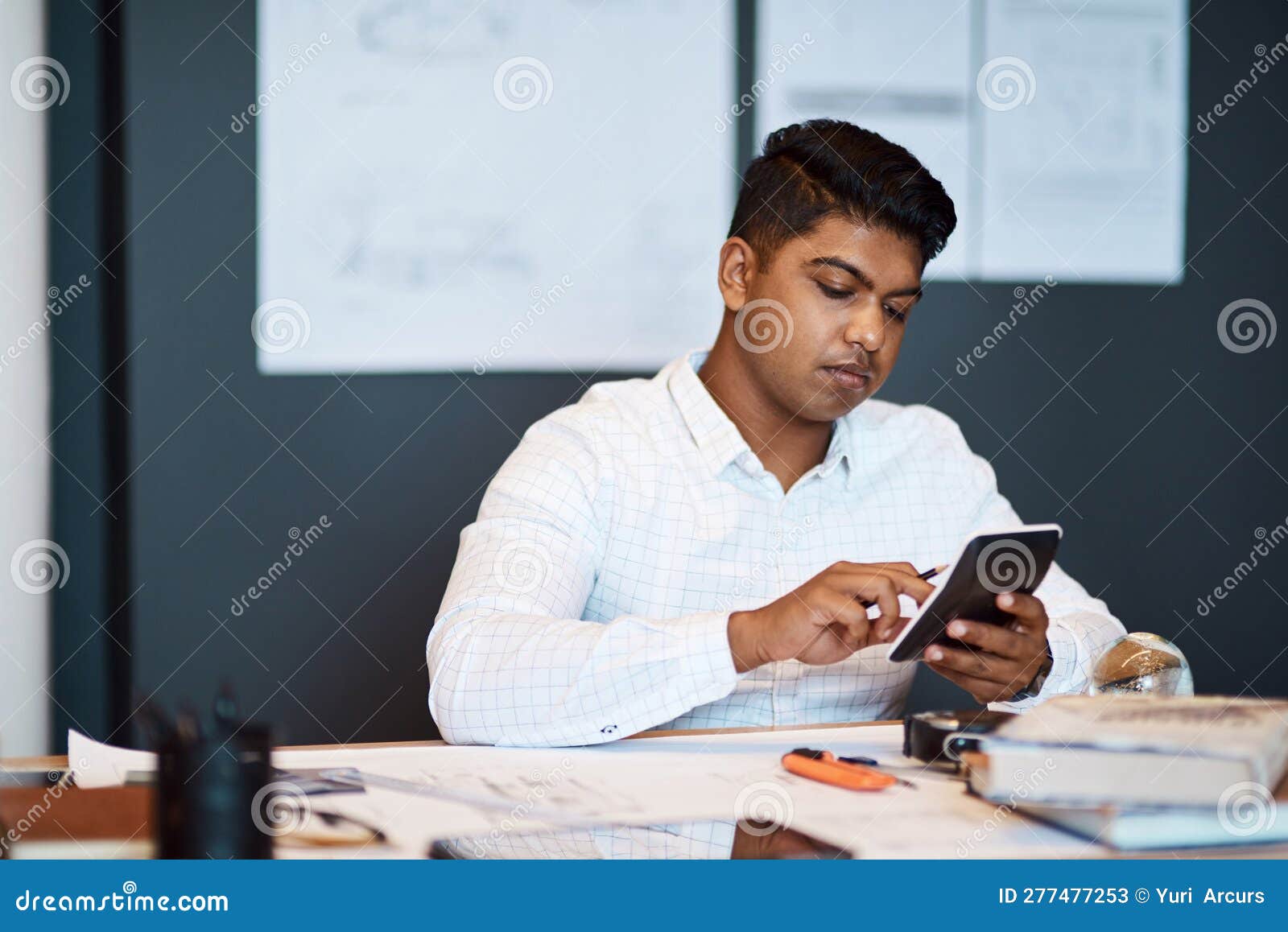 Dedication Gets the Design Done. a Young Architect Using a Calculator ...