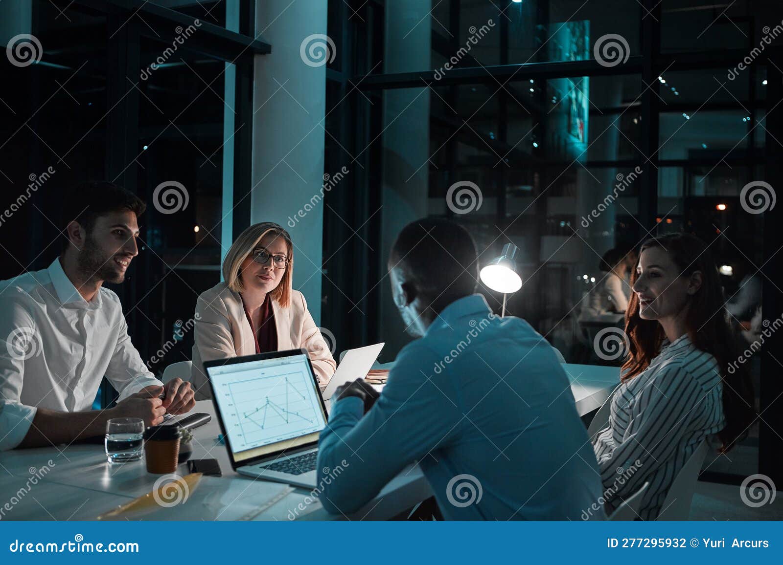 Dedication Gets Things Done. Colleagues Having a Meeting during a Late ...