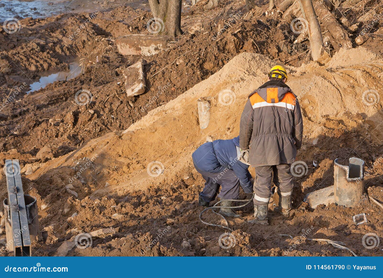 Two Mans Builder Workers Digging in Soil in Construction Pit. Editorial ...