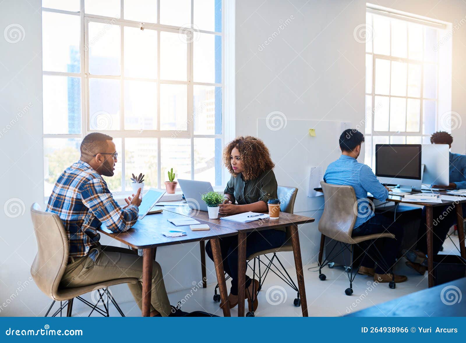 Deep in a Creative Discussion. Two Young Coworkers Having a Discussion ...