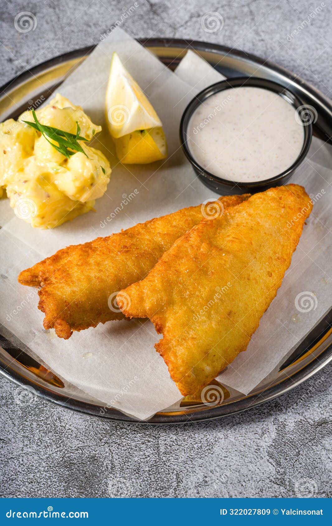 Deep Fried Coated Fish Fillet with Potato Salad on Stone Table Stock ...